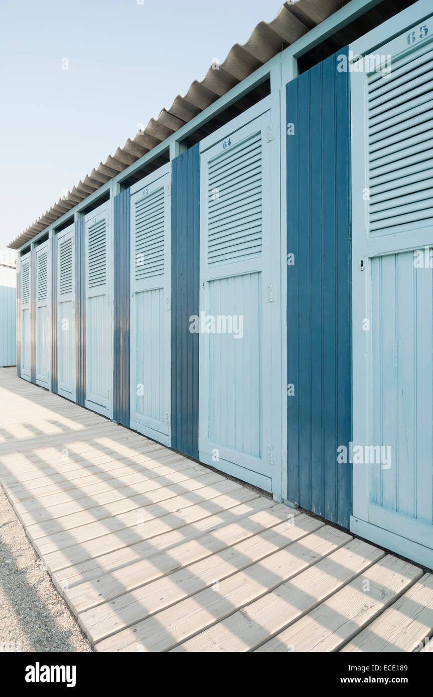 In a row changing cubicle beach summer Italy blue Stock Photo - Alamy