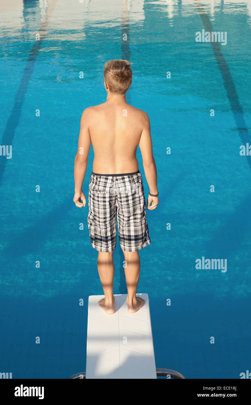 Swimming pool boy diving board fun holiday Stock Photo - Alamy