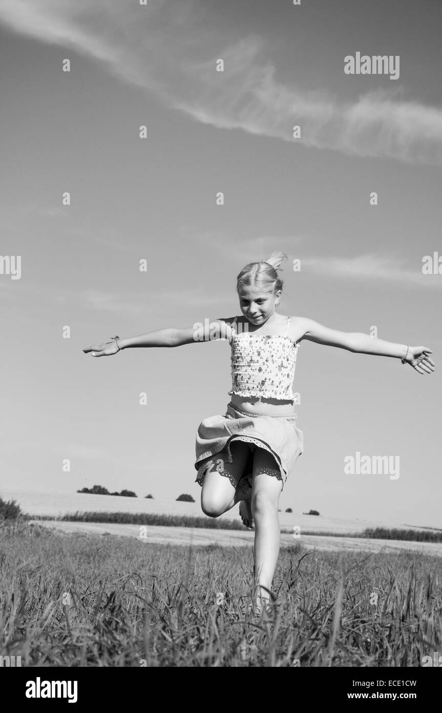 Young happy girl running field black and white Stock Photo - Alamy