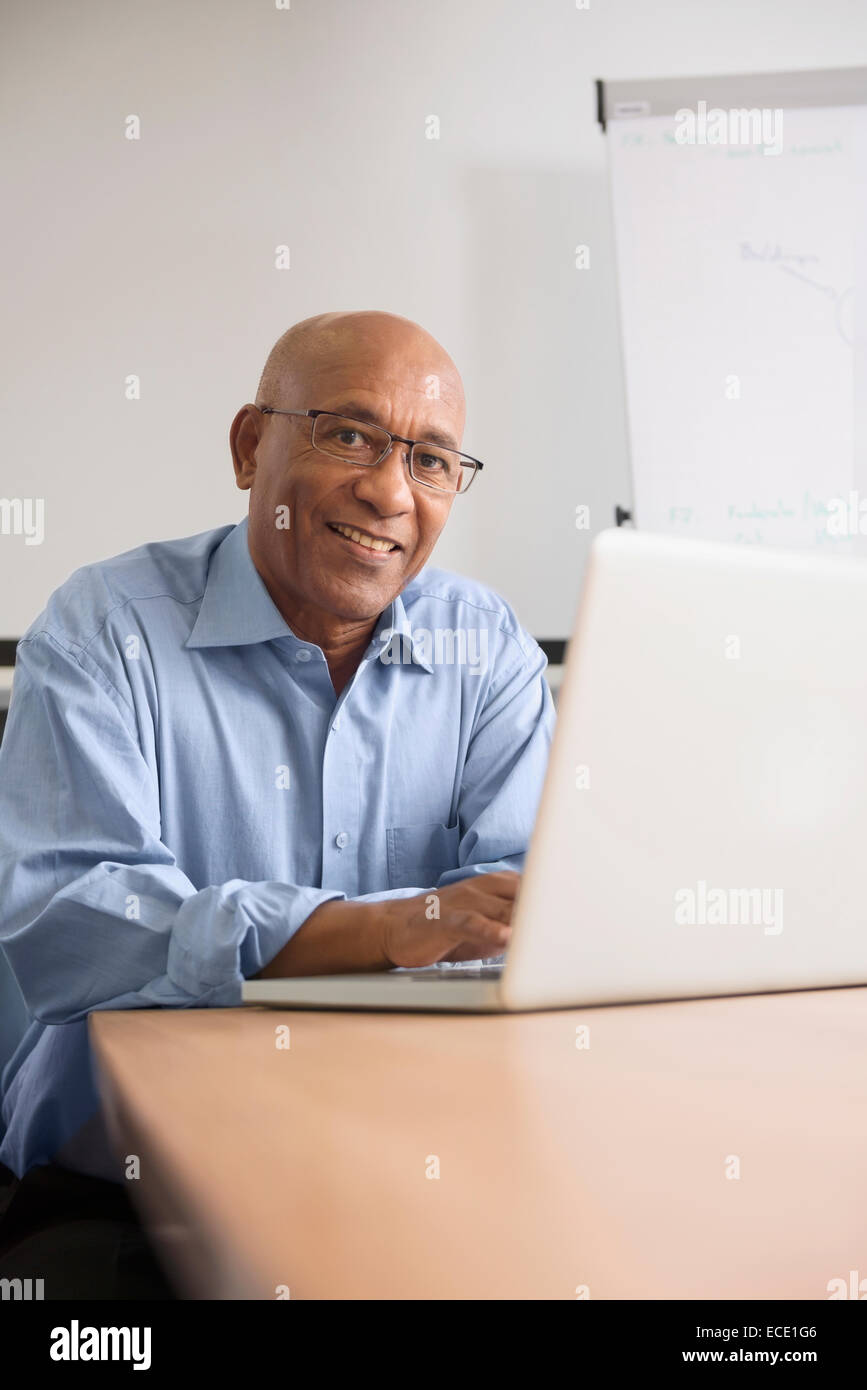 Portrait man office African laptop computer Stock Photo - Alamy