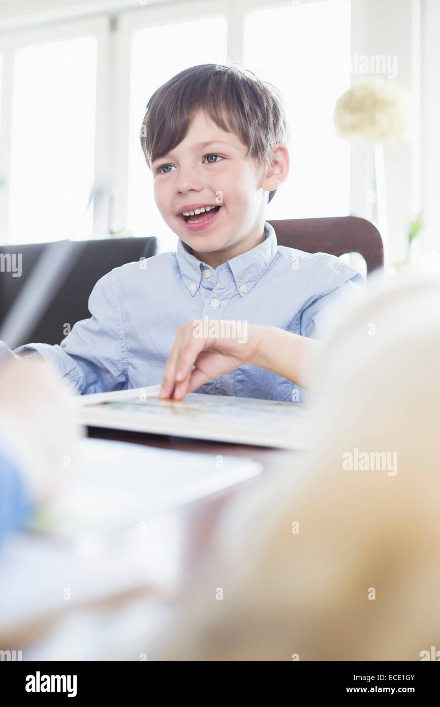 Boy doing his homework, smiling Stock Photo - Alamy