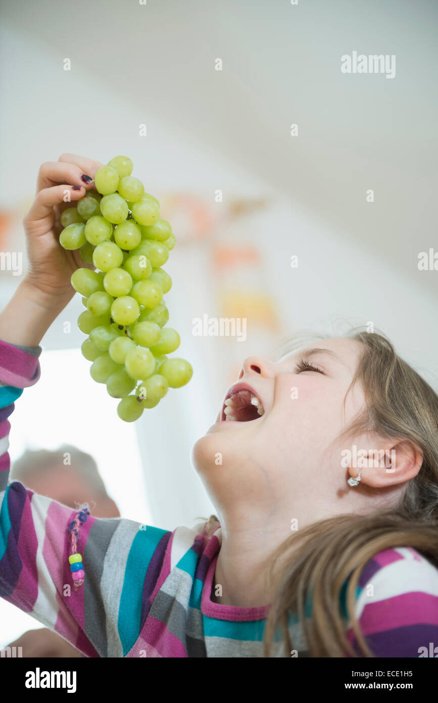 Girl eating grapes hi-res stock photography and images - Alamy