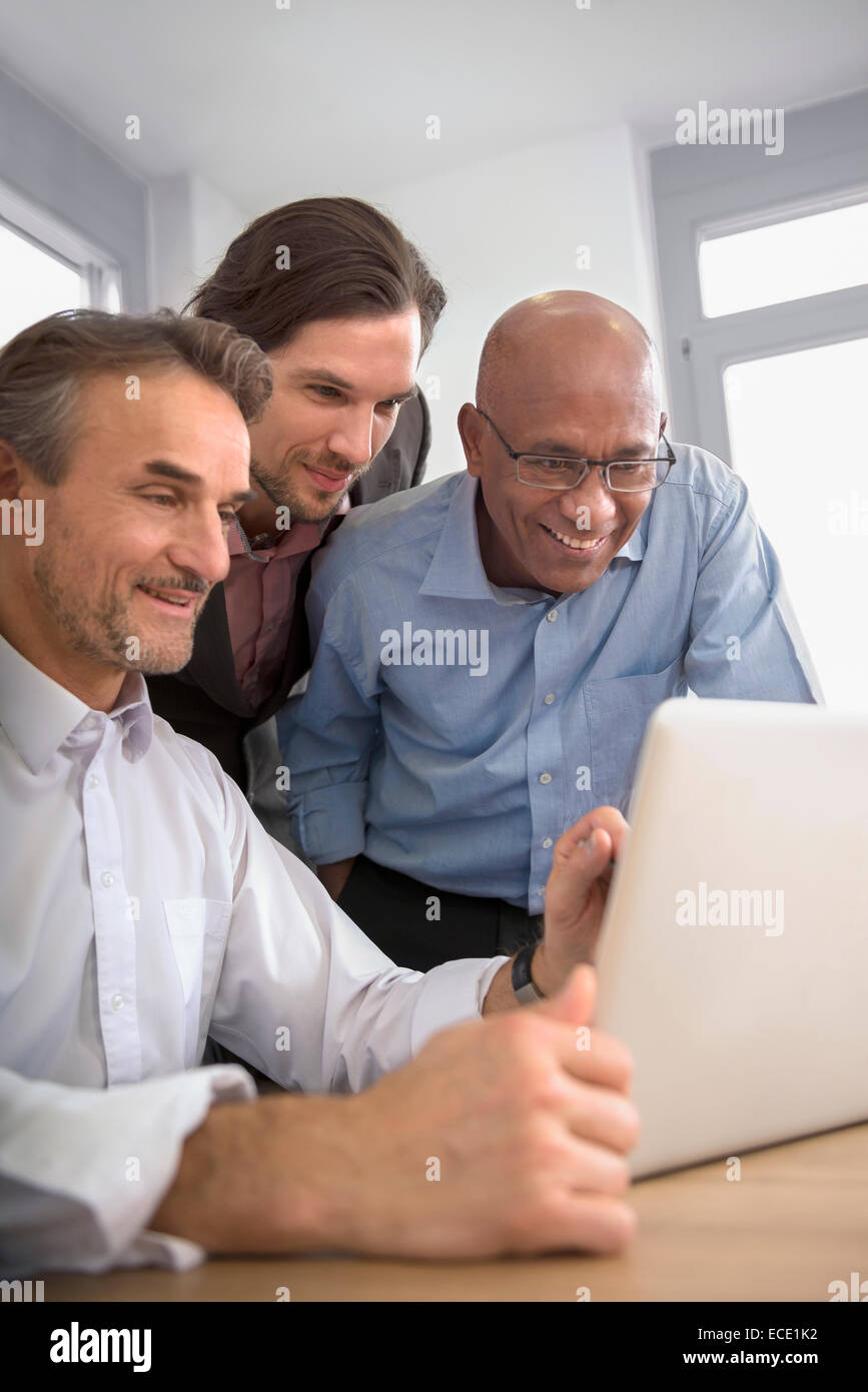 Three businessmen office meeting Brainstorming Stock Photo - Alamy