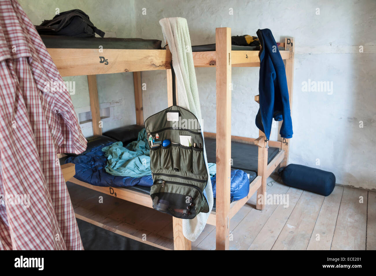 Wooden bunk beds cabin clothes hanging Stock Photo - Alamy