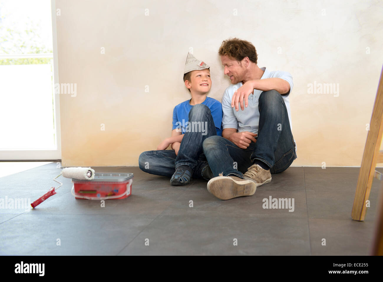 Father son working taking a break decorating Stock Photo - Alamy