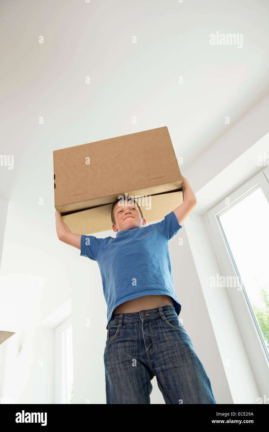 From below boy carrying box new room home Stock Photo - Alamy