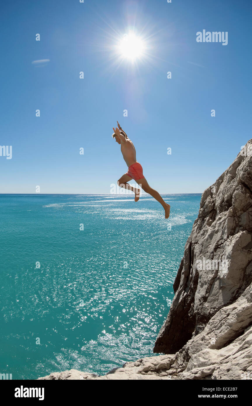 Teenager risk danger ocean holiday jump dive water Stock Photo - Alamy