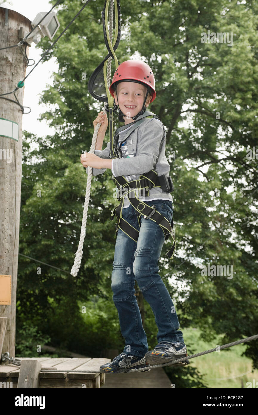 Boy climbing crag, smiling Stock Photo - Alamy