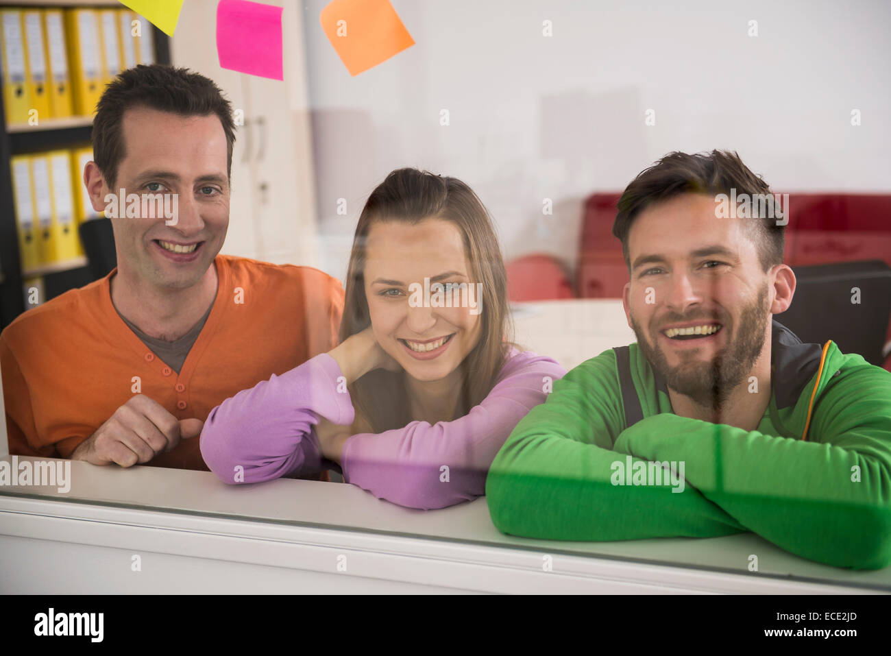 Portrait three happy young work colleagues office Stock Photo - Alamy