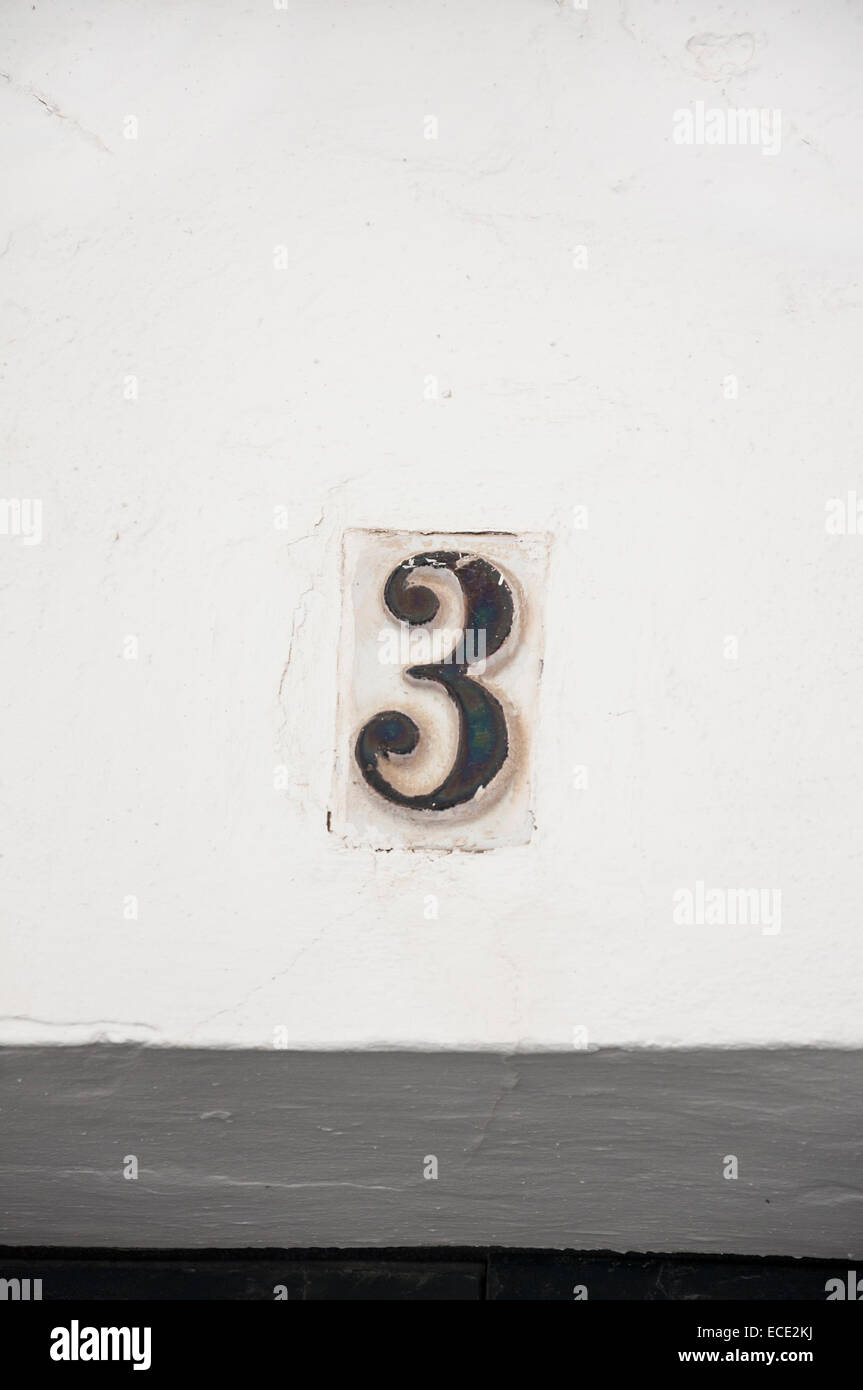 Close up detail house number wall three Stock Photo - Alamy