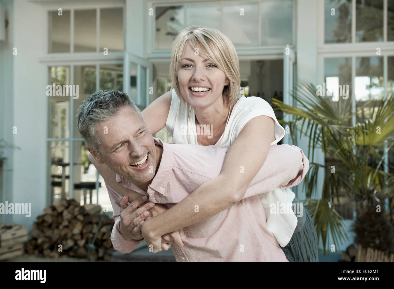 Couple married garden middle aged fun playful Stock Photo - Alamy