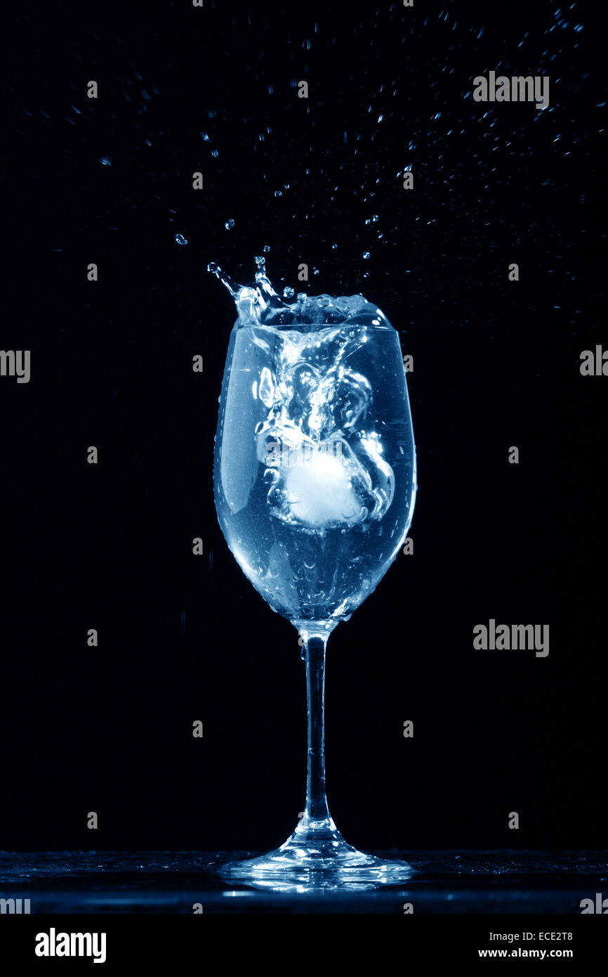 alcohol splash on black background Stock Photo - Alamy