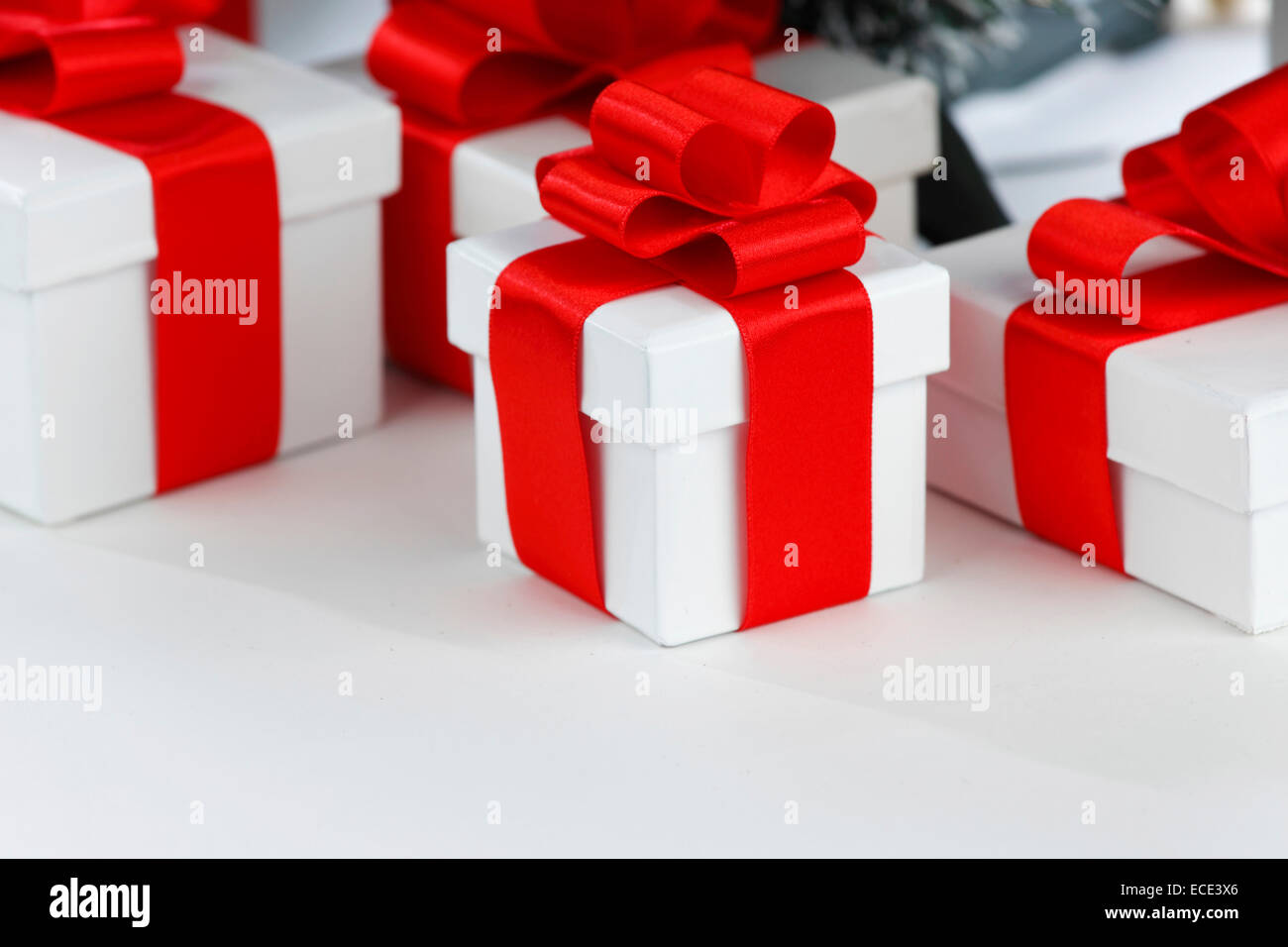 Many gift boxes with red ribbons isolated on white background Stock ...