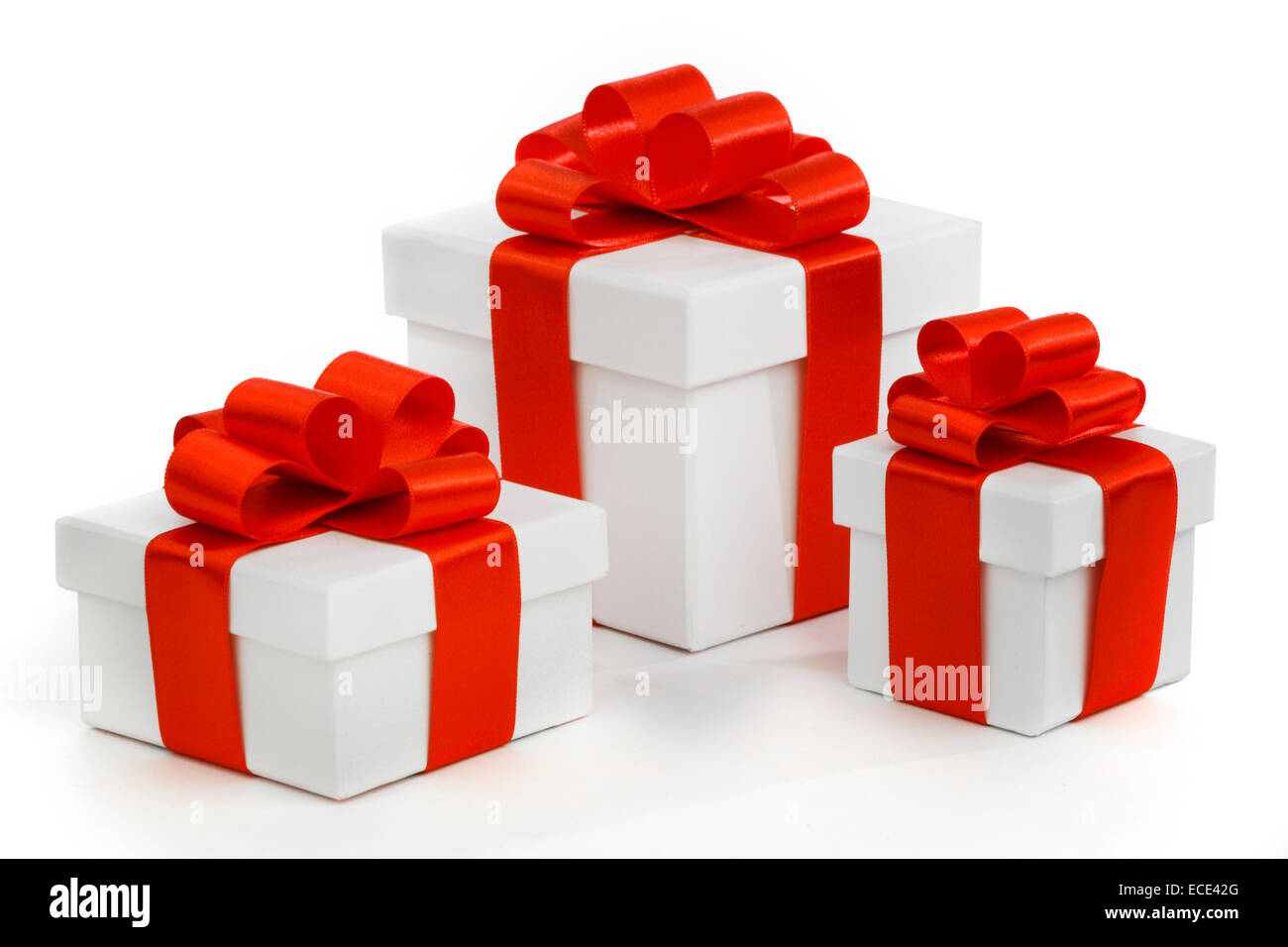 Gift boxes with red ribbon bows on white background Stock Photo - Alamy