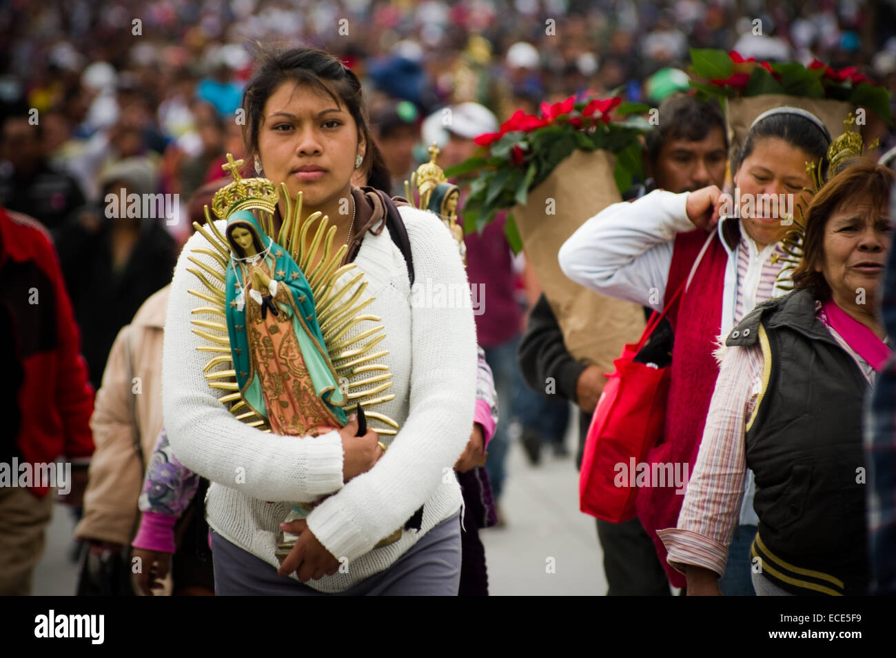 Mexico City, Mexico. 11th Dec, 2014. A lady arrives with a statue of ...