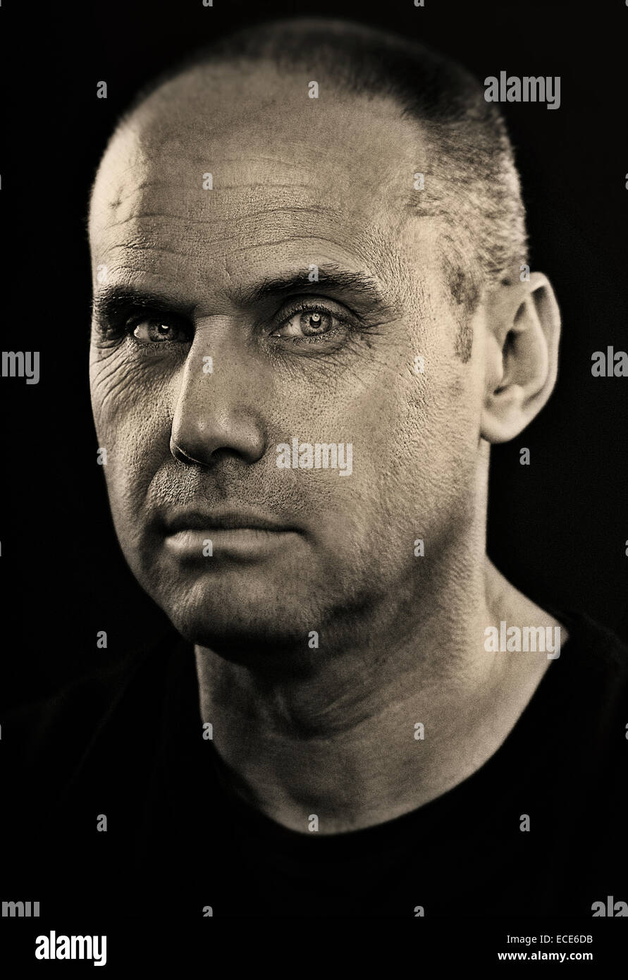 A white European male age 50. The image is a portrait in color against ...