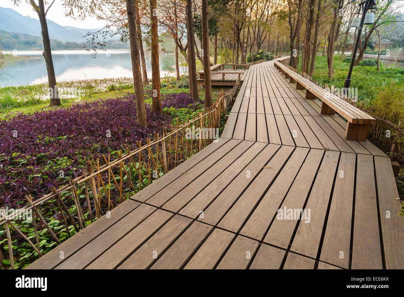 Wooden pathway on the coast. Walking around famous West Lake park in ...