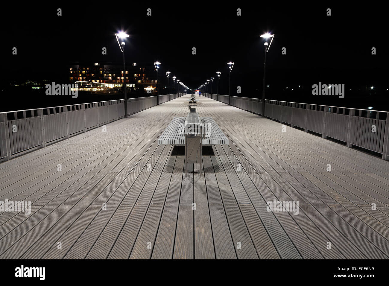 Night view of a boardwalk, bench and lamp posts Stock Photo - Alamy