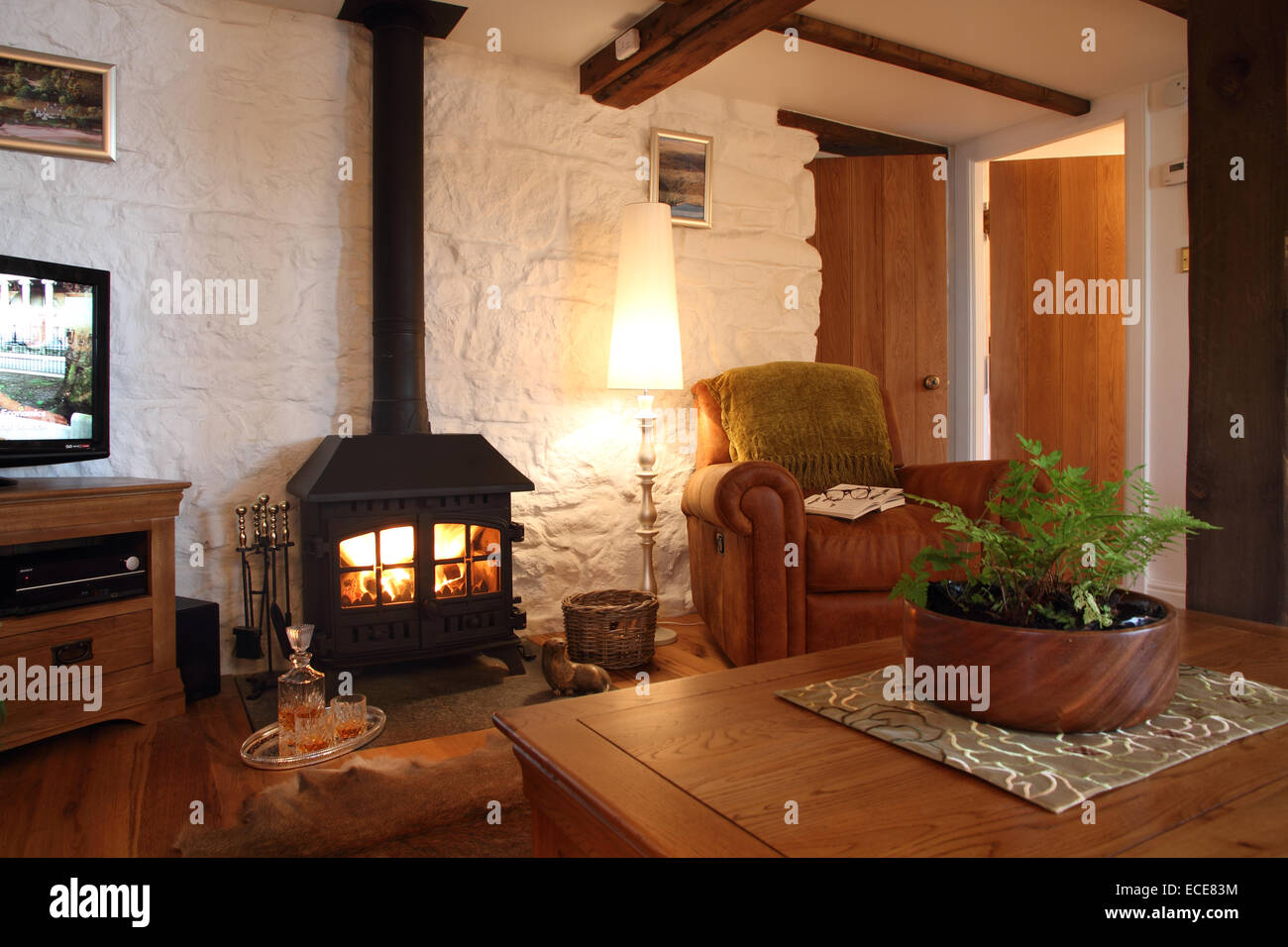 Cosy living/sitting room with fire Stock Photo - Alamy