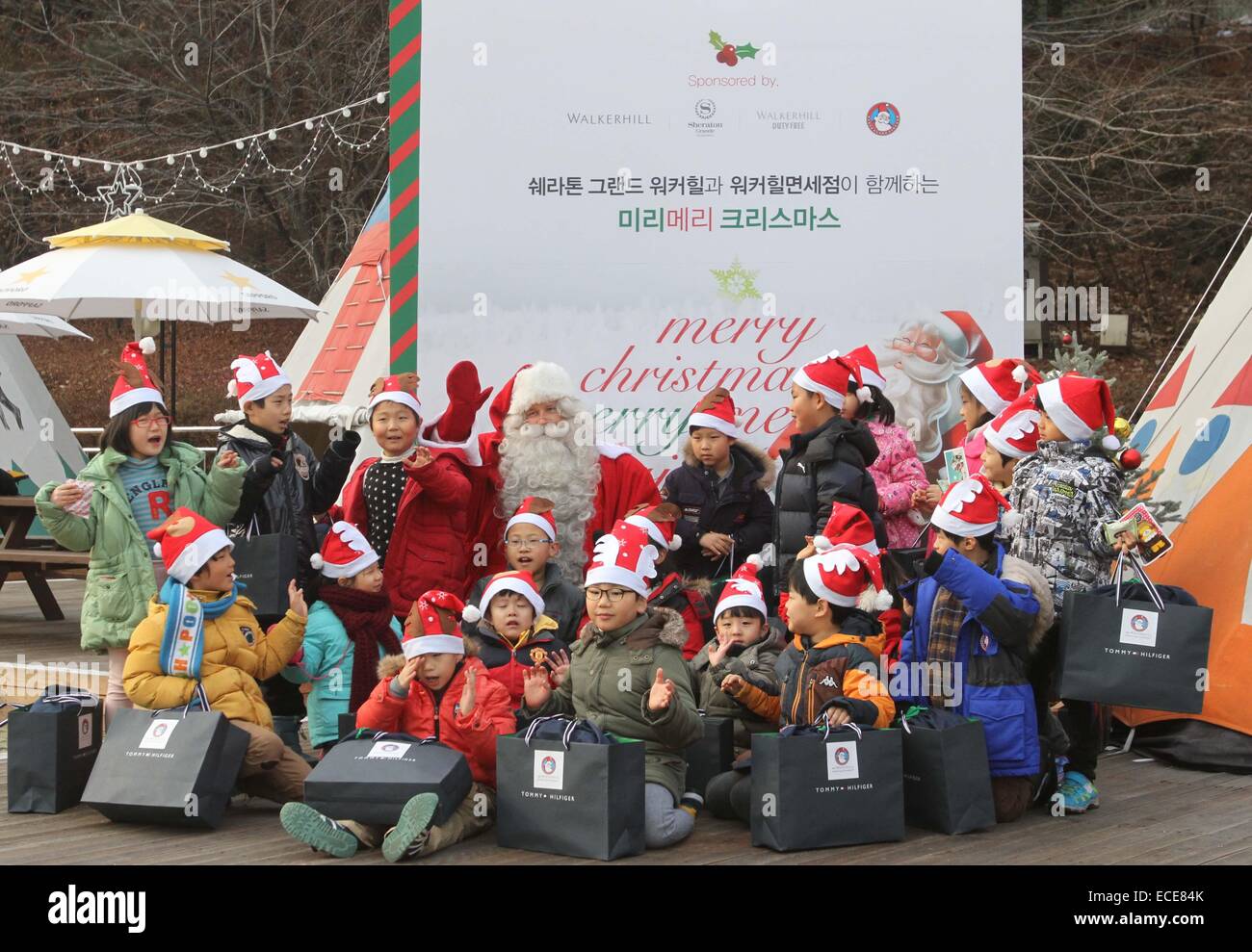 Seoul, South Korea. 12th Dec, 2014. Kids pose for a photo with Santa ...