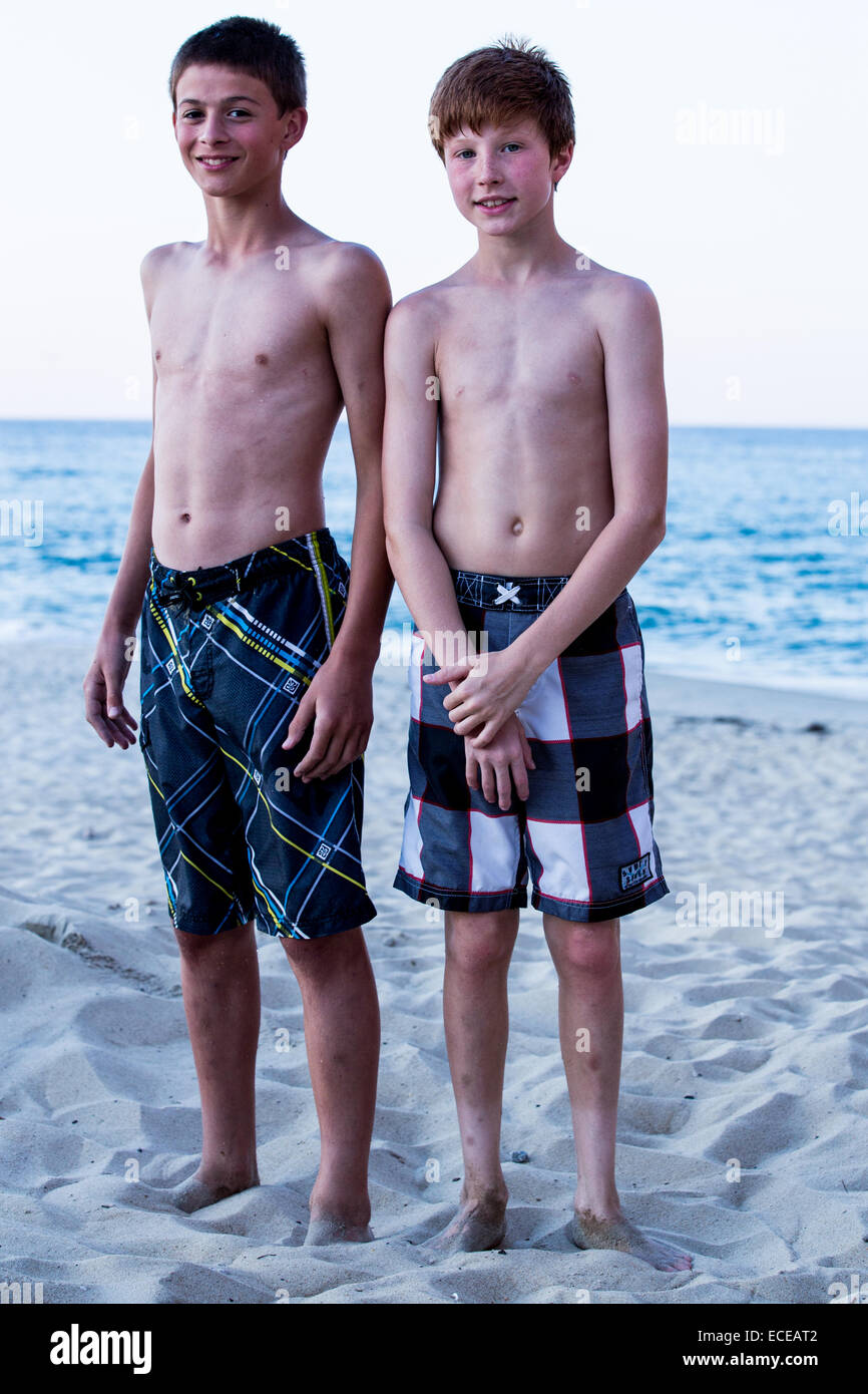 Portrait of two boys standing on beach Stock Photo - Alamy