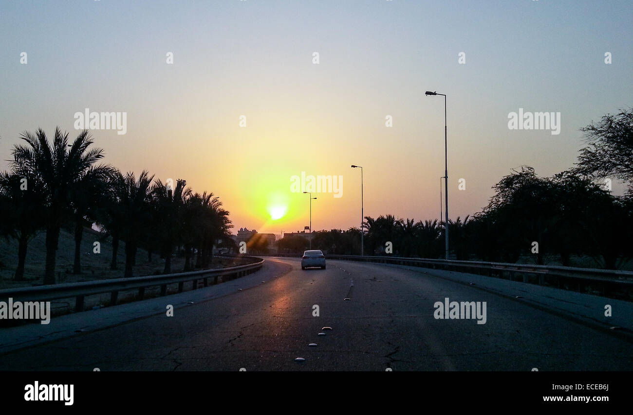 Lone car on the road at sunset Stock Photo - Alamy