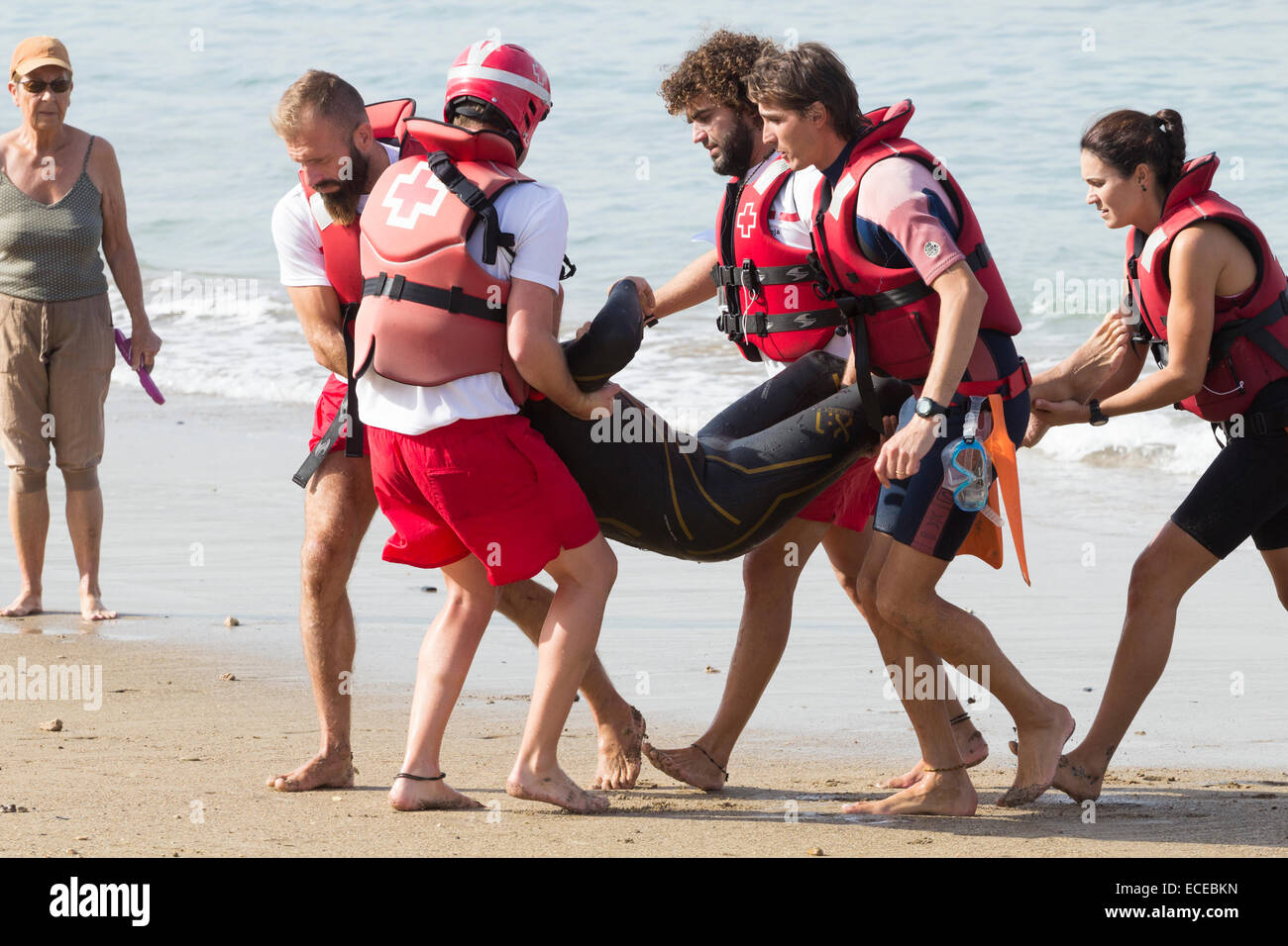 Red Cross Lifeguards and rescue services rescue simulation on beach in ...