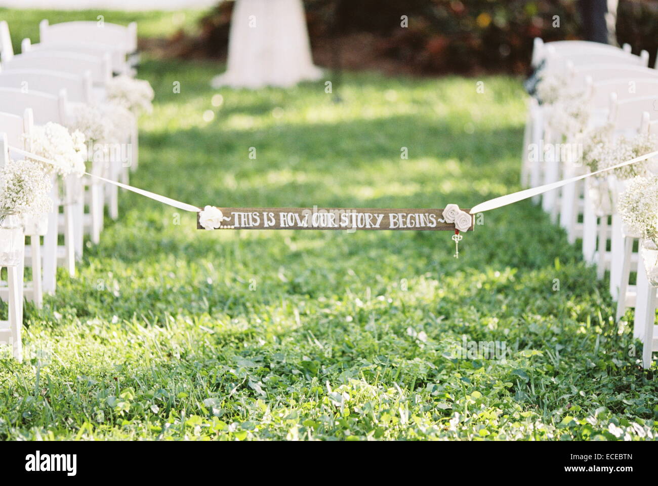 Wedding banner hanging across aisle between rows of chairs Stock Photo ...