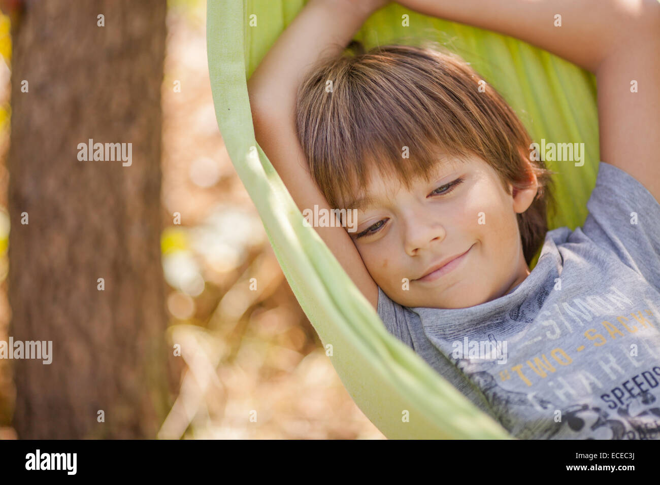 Portrait of smiling boy lying in hammock Stock Photo - Alamy
