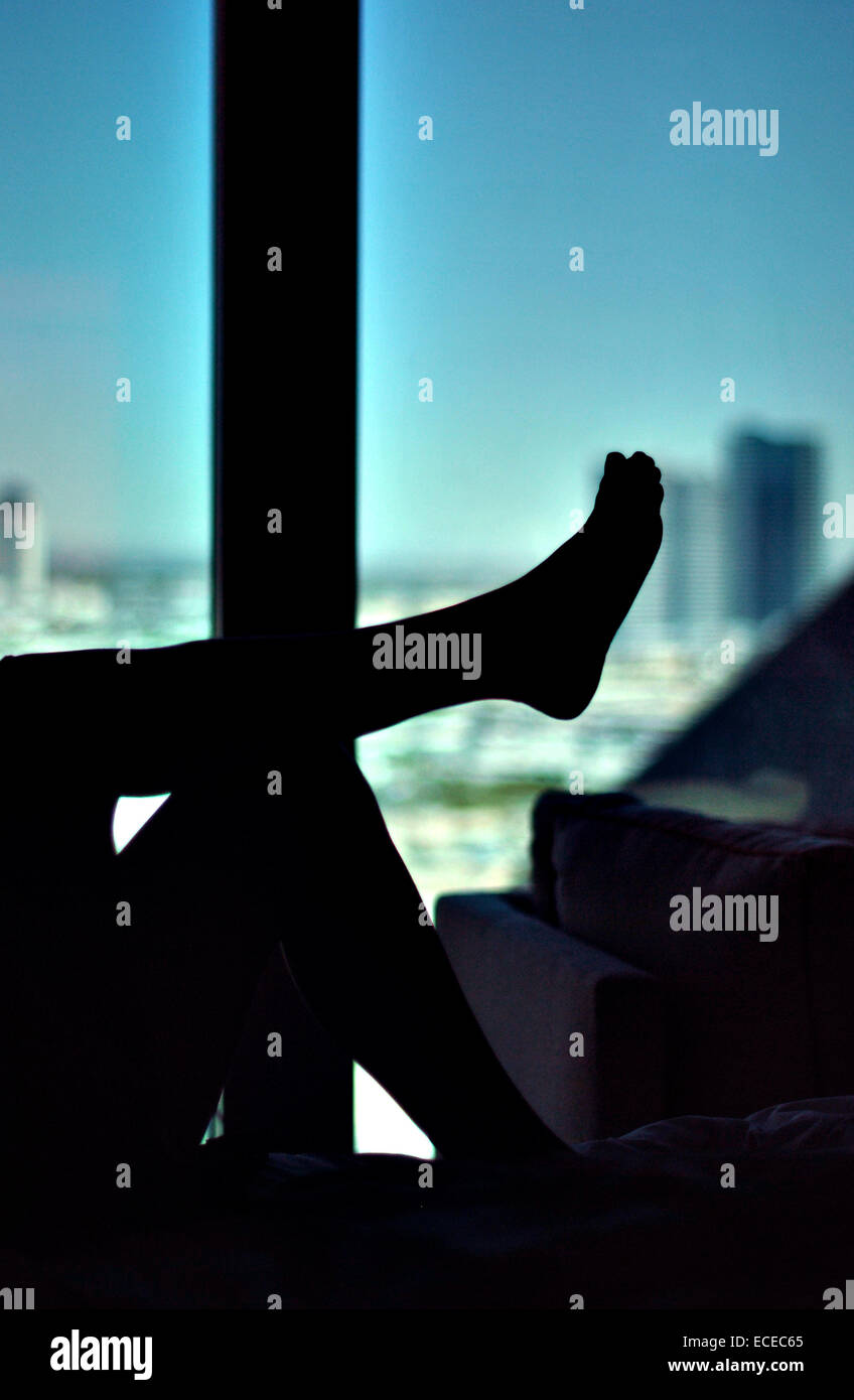 Silhouette of woman's leg against window Stock Photo - Alamy