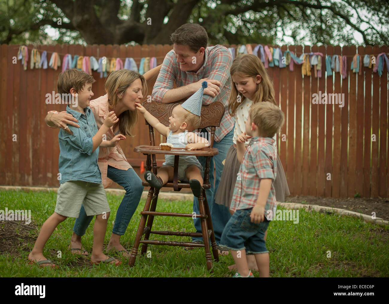 Family celebrating baby boys' first birthday in back yard Stock Photo ...