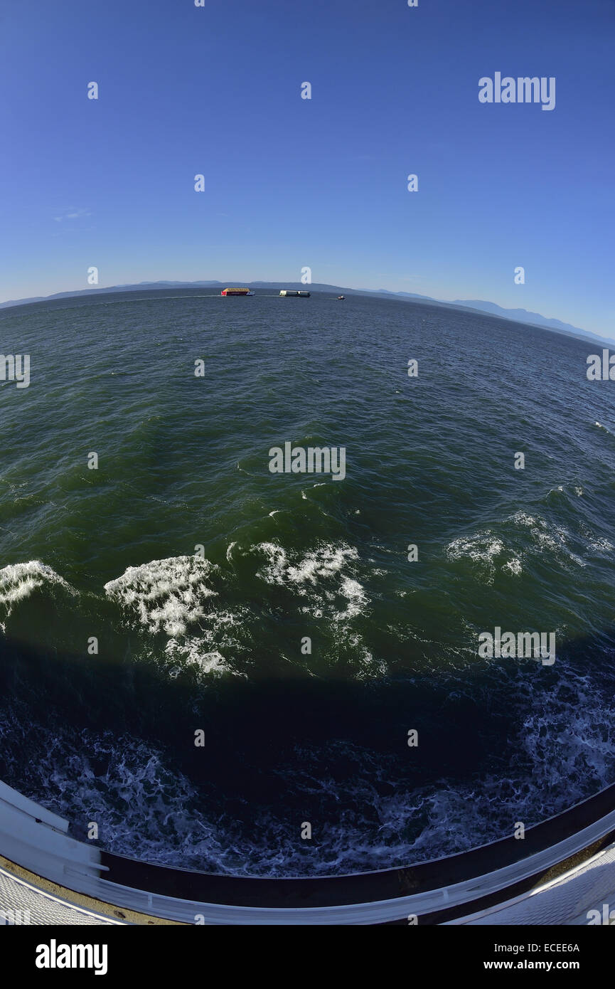 A vertical fisheye image from the side of the ferry boat showing a tug ...
