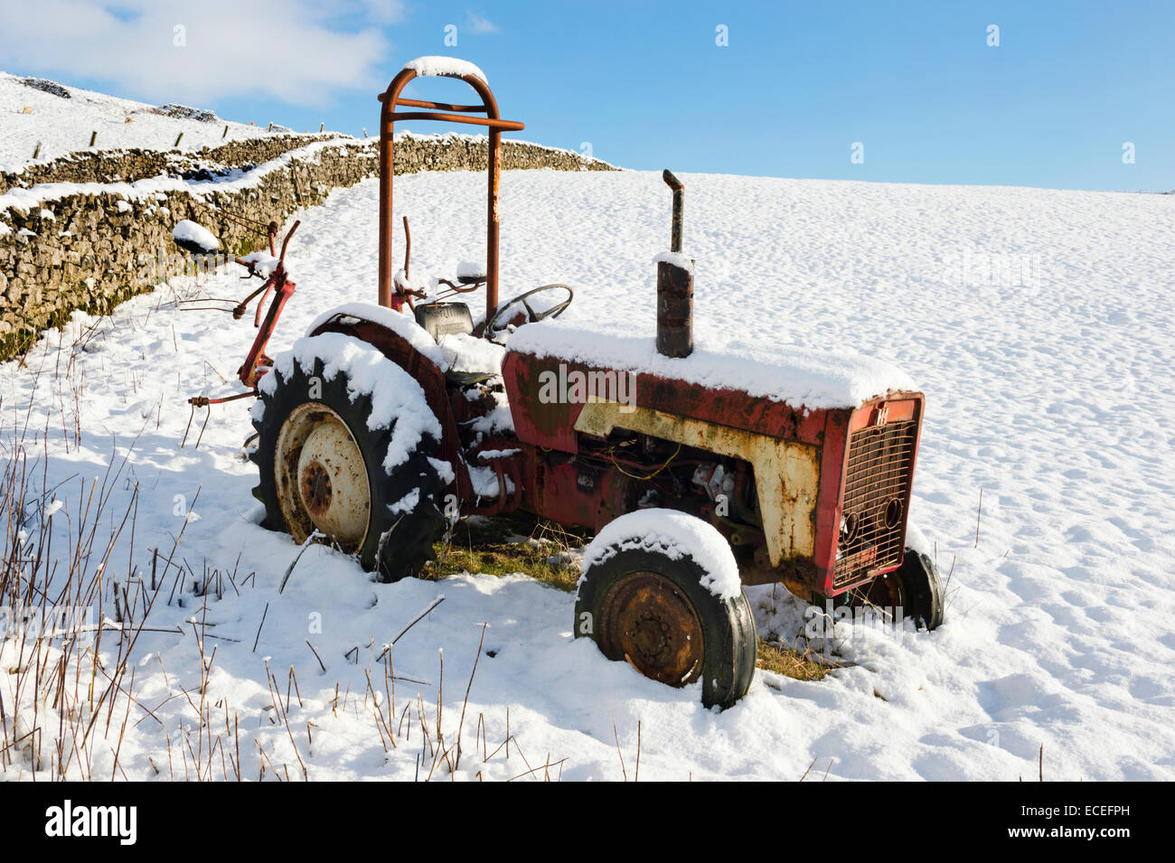 Old tractor in the snow near Settle, North Yorkshire, UK. Snowfall with ...