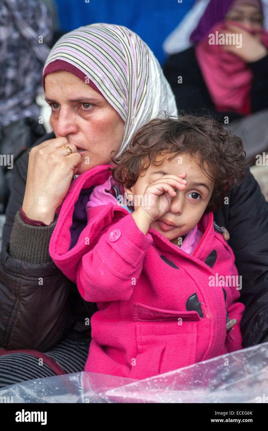 Syrian refugees in Athens. Syrian mother with her two children. Syrian ...