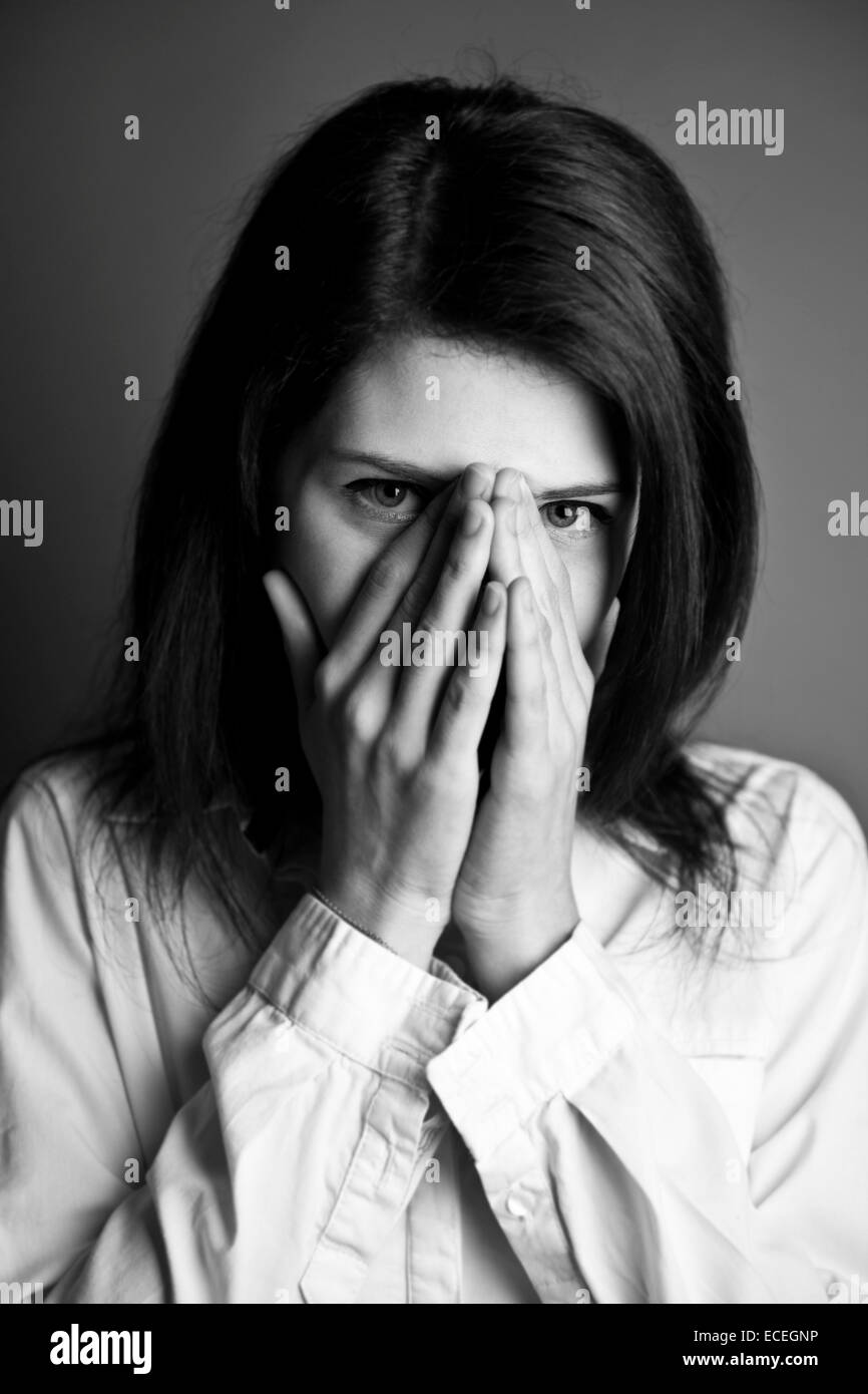 Portrait of a young woman with hands on face Stock Photo - Alamy