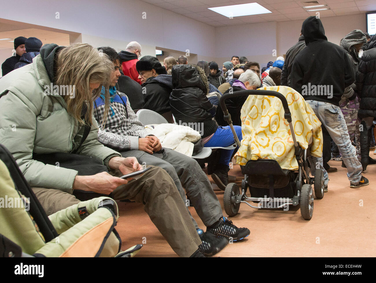 Asylum seekers wait inside the Berlin Central Reception Facility for ...