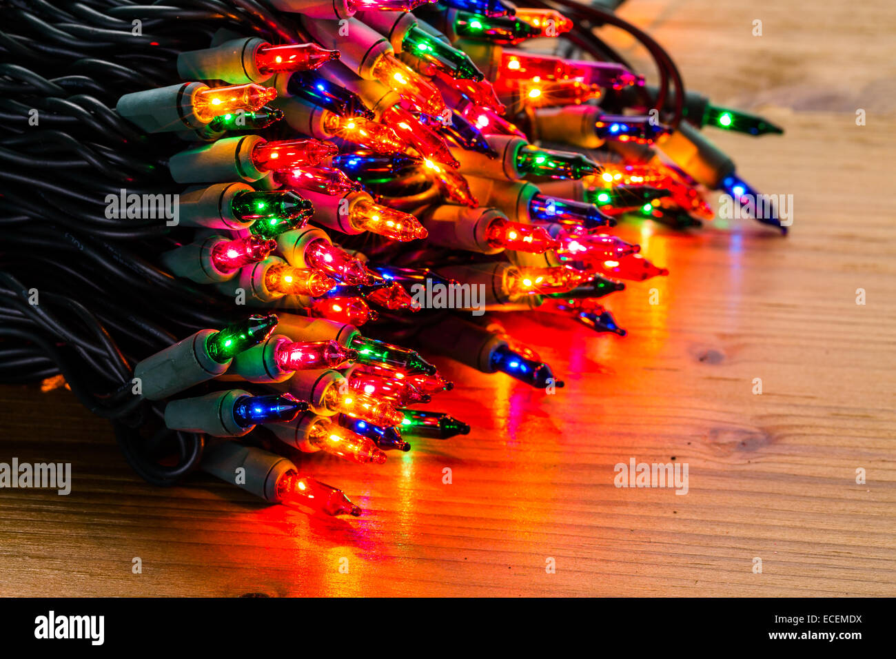 String of multicolor Christmas lights with green wiring Stock Photo - Alamy