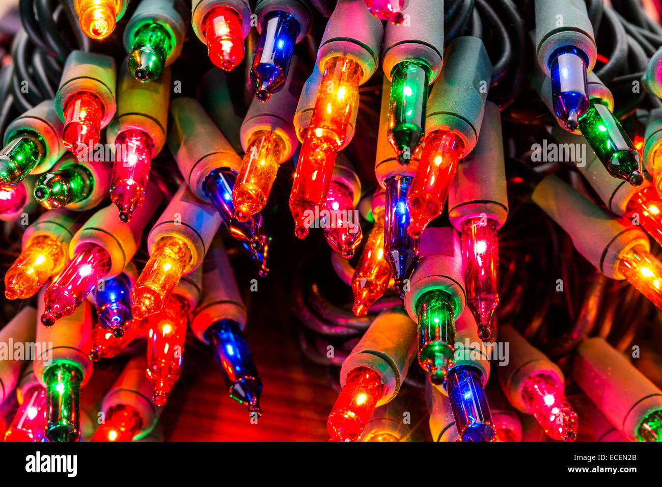 String of multicolor Christmas lights with green wiring Stock Photo - Alamy