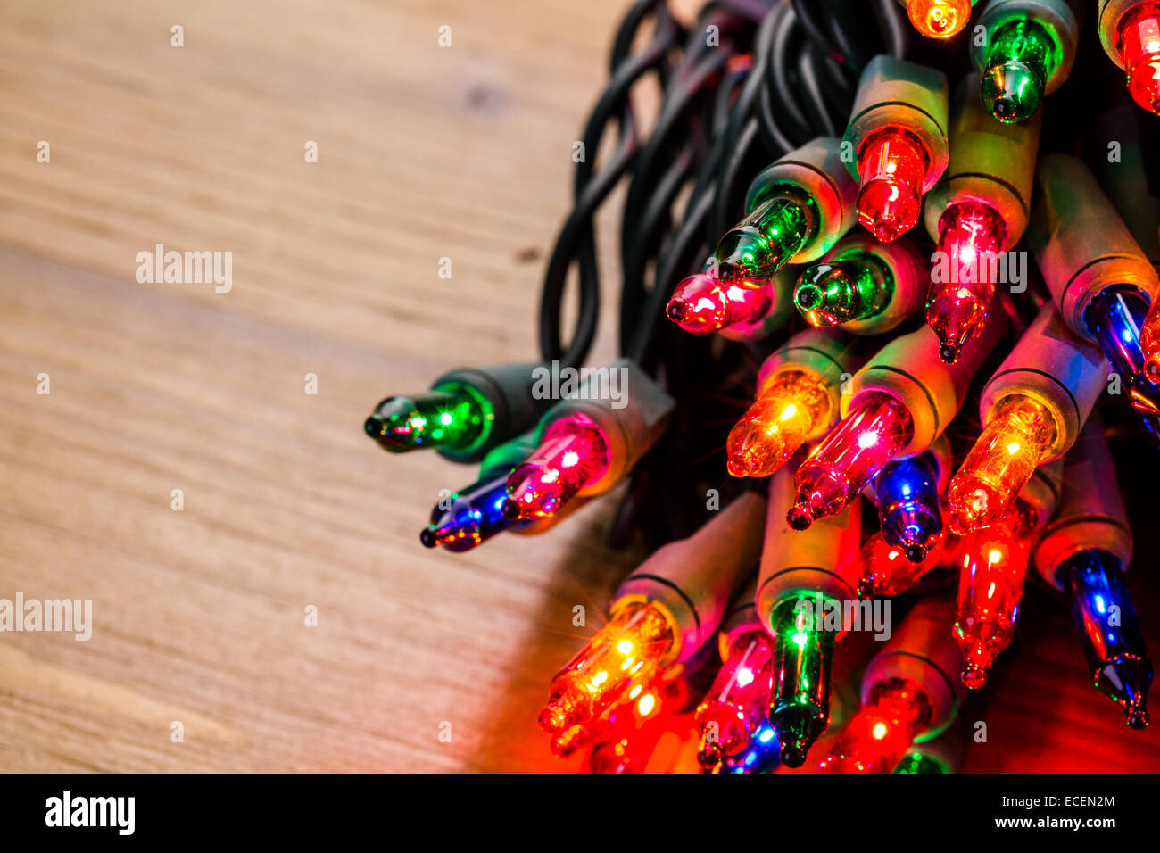 String of multicolor Christmas lights with green wiring Stock Photo - Alamy
