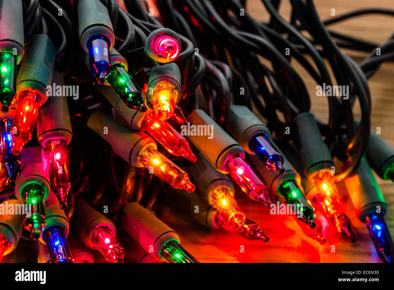 String of multicolor Christmas lights with green wiring Stock Photo - Alamy
