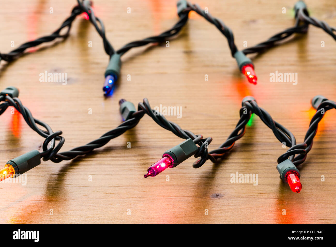 String of multicolor Christmas lights with green wiring Stock Photo - Alamy