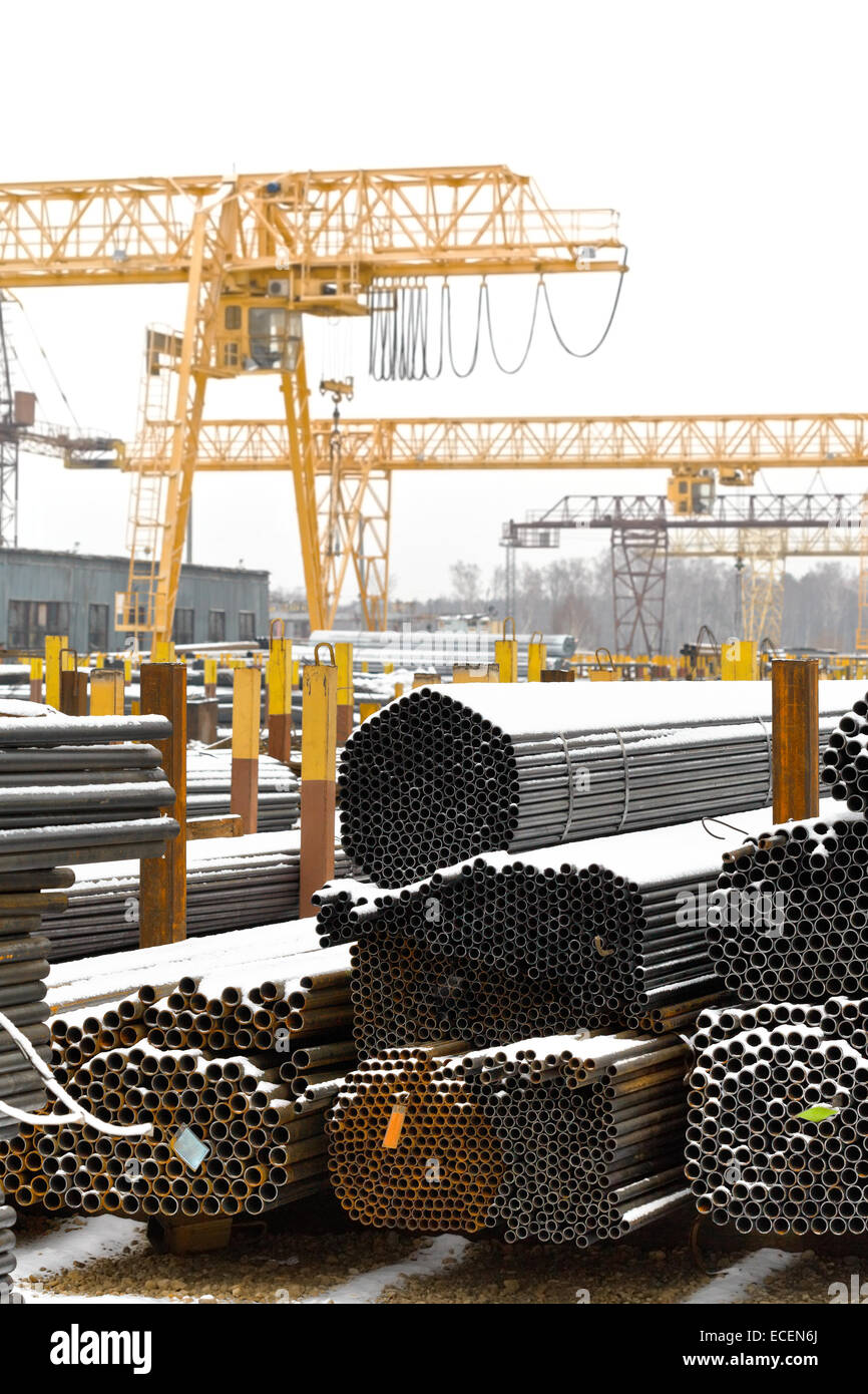 storing of metal pipes in outdoor warehouse with gantry cranes Stock ...