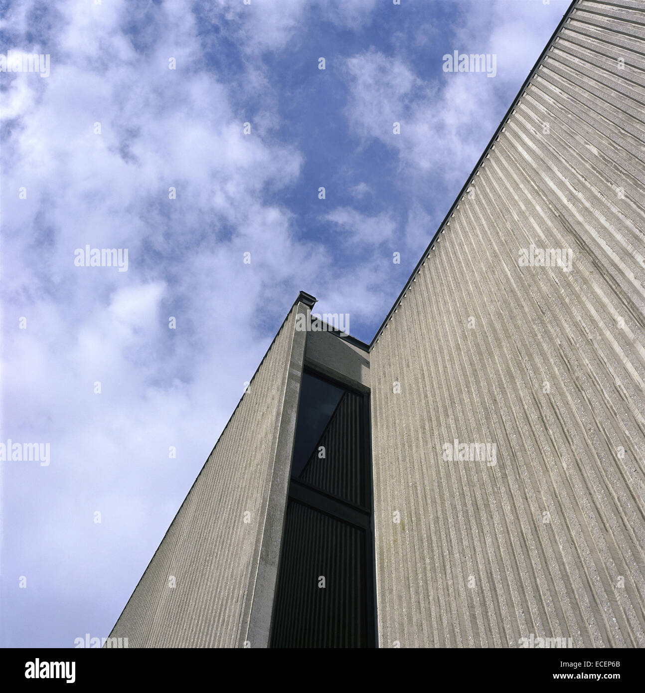 Large, modern concrete building and cloudy sky Stock Photo - Alamy