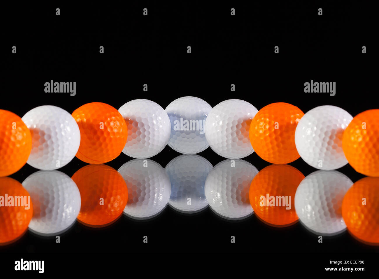 Golf balls on the black glass table Stock Photo - Alamy