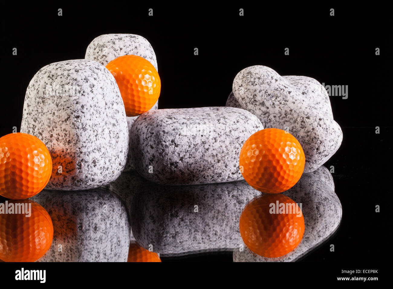 Granite stones and golf balls Stock Photo - Alamy