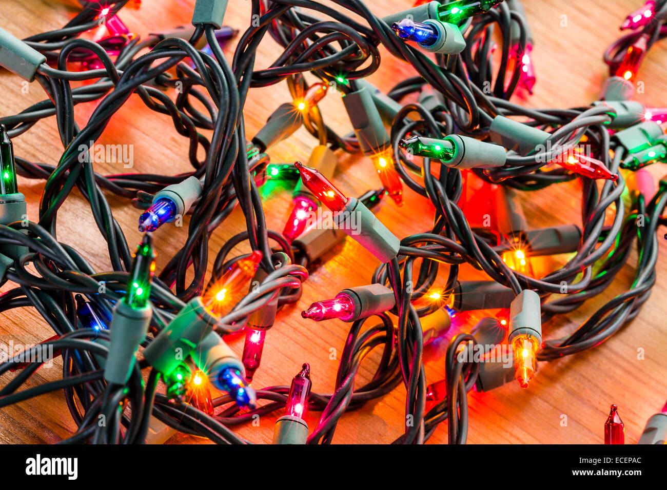 String of multicolor Christmas lights with green wiring Stock Photo - Alamy