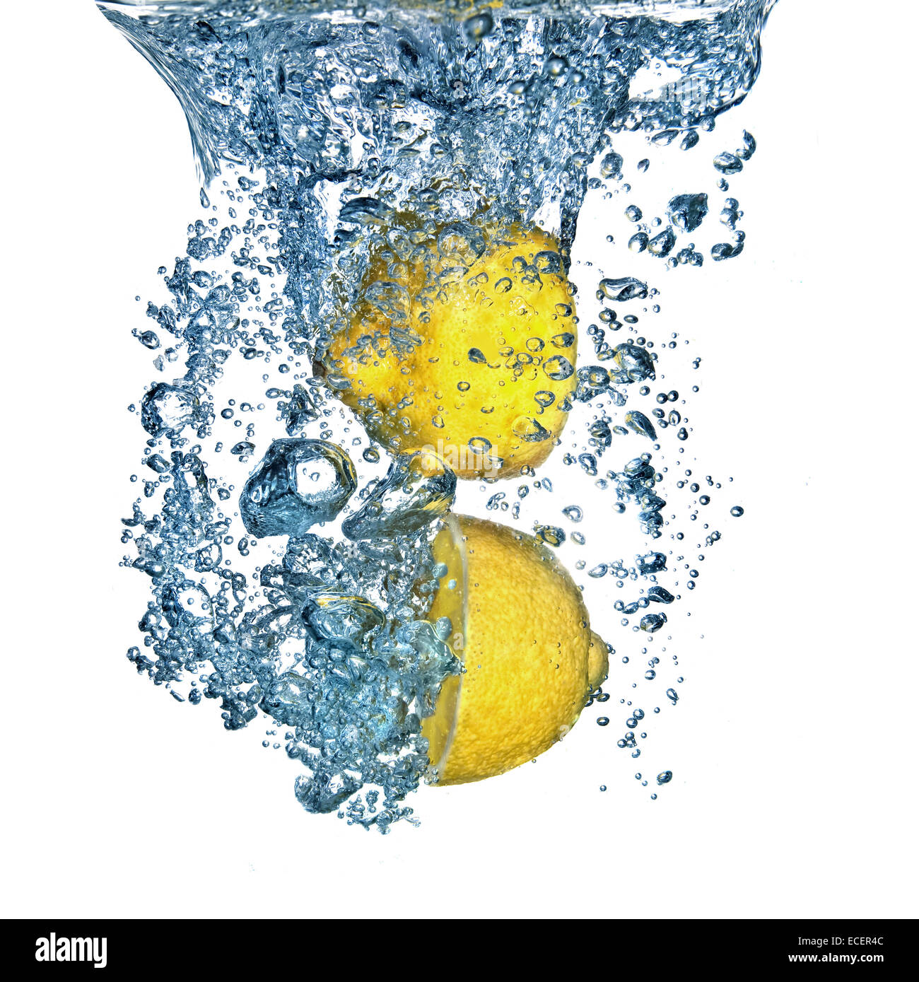 Fresh lemon dropped into water with bubbles isolated on white Stock ...