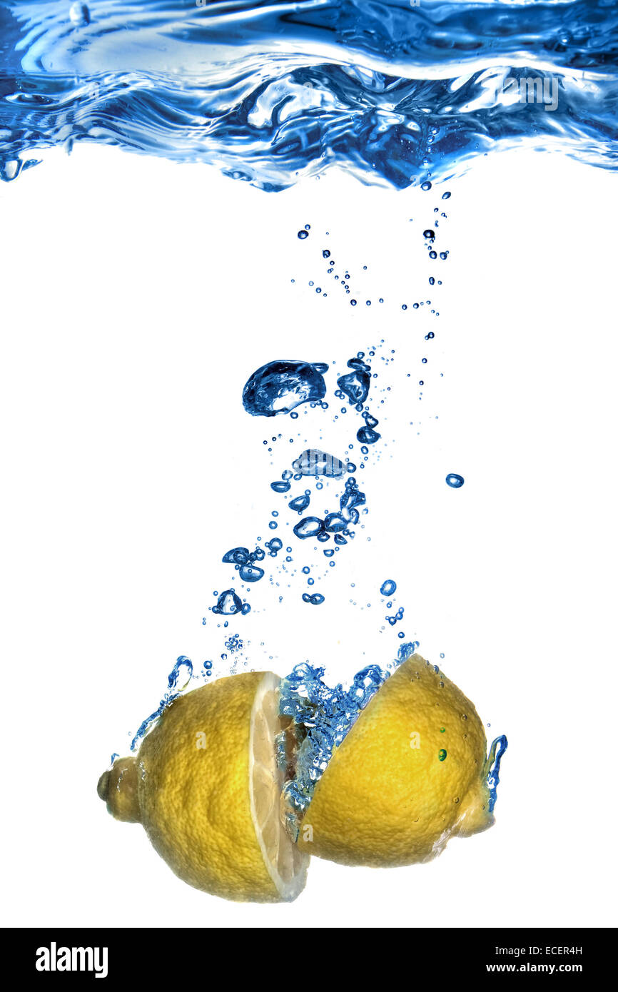 Fresh lemon dropped into water with bubbles isolated on white Stock ...