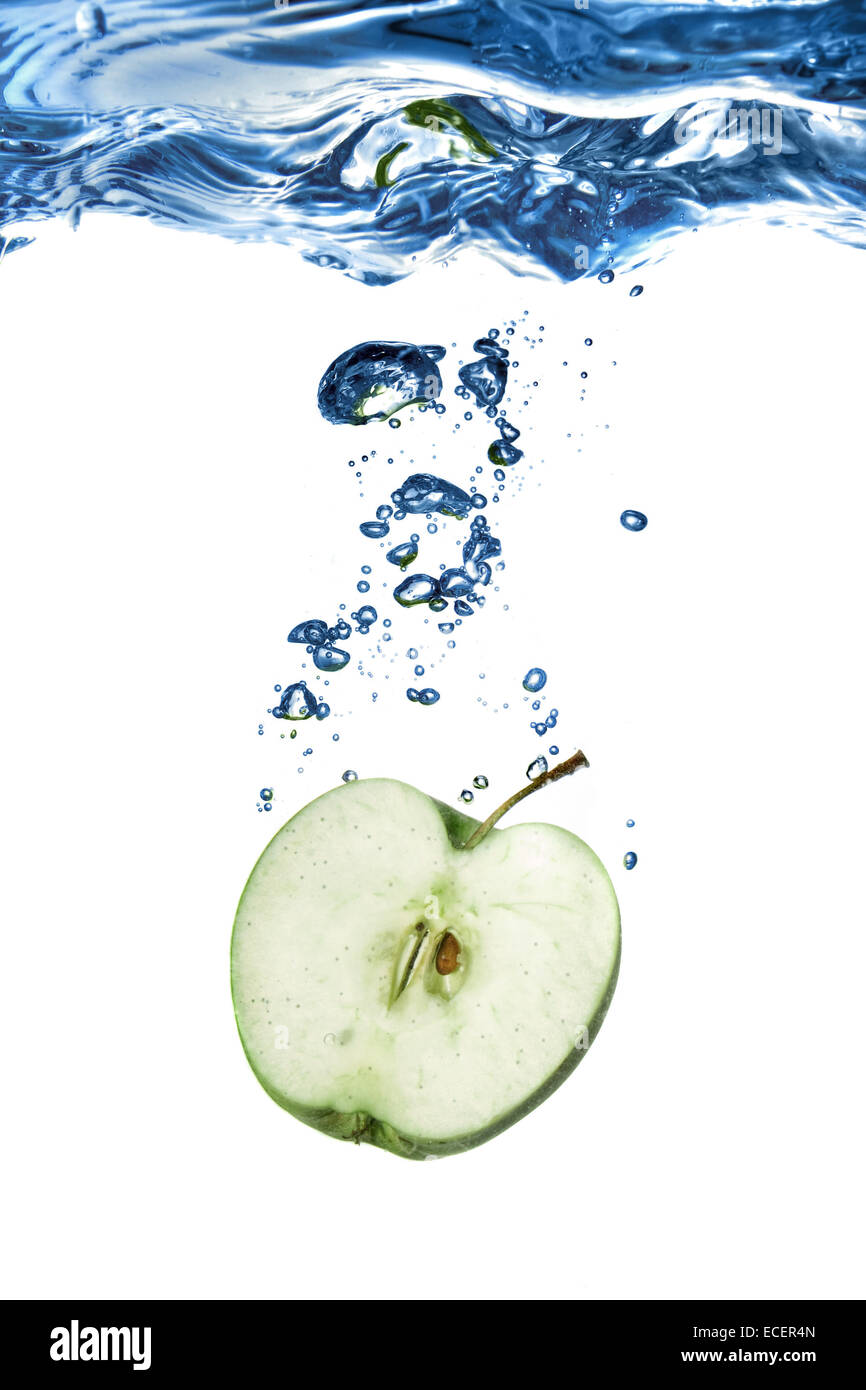 green apple dropped into water with bubbles isolated on white Stock ...