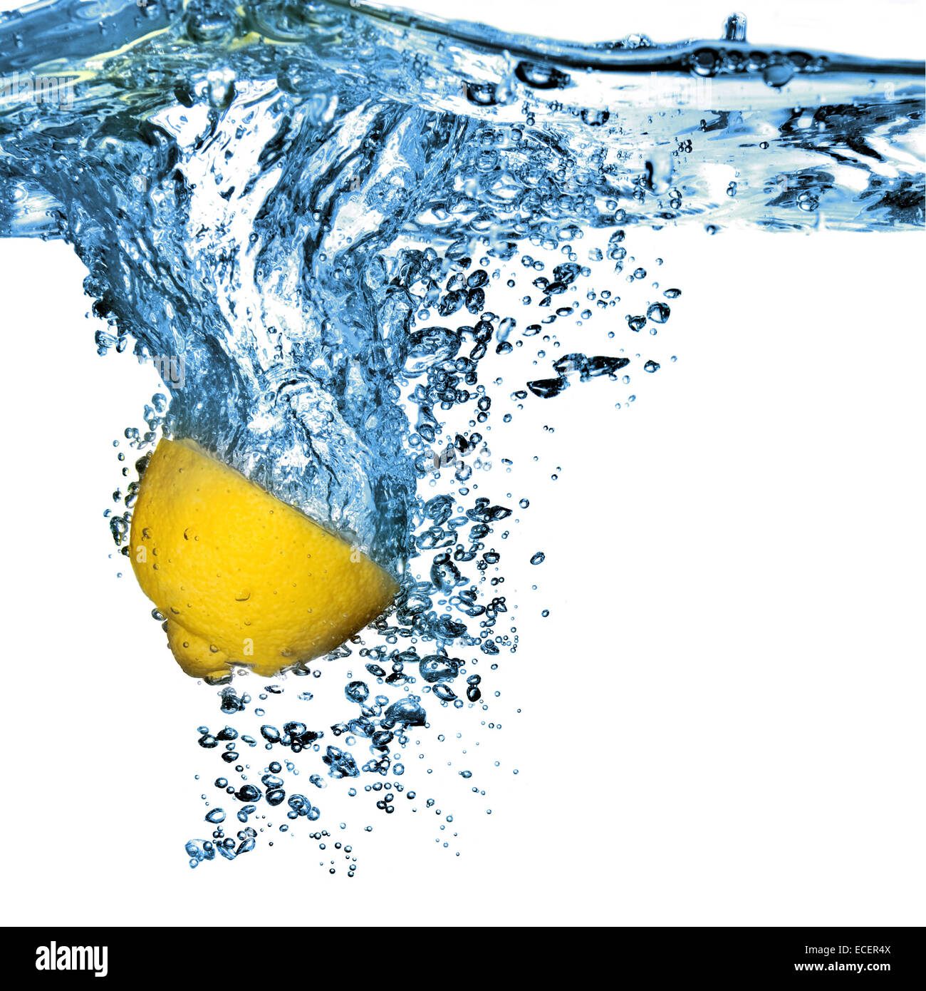 Fresh lemon dropped into water with bubbles isolated on white Stock ...